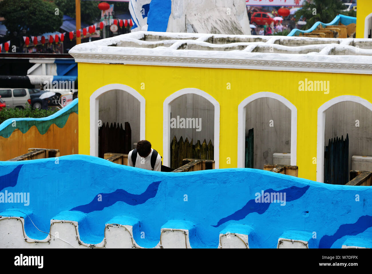 A male tourist is pictured at an open public toilet in a scenic spot in ...