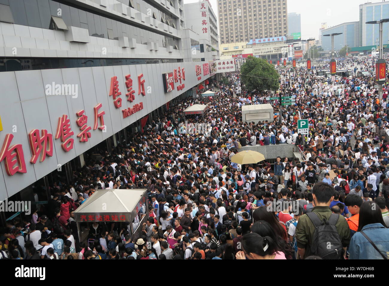 Chinese passengers crowd the Zhegnzhou Railway Station ahead of the ...