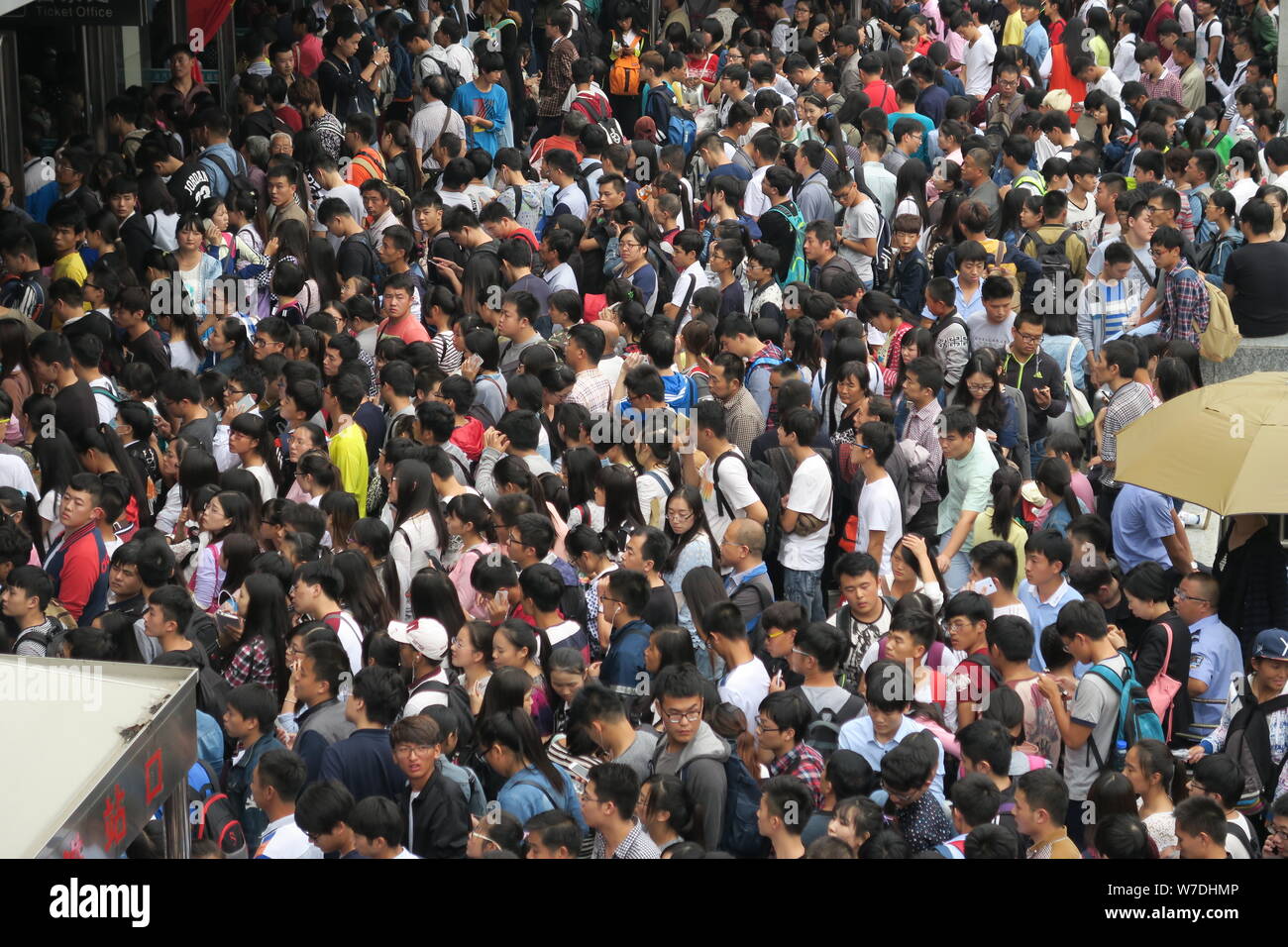 Chinese passengers crowd the Zhegnzhou Railway Station ahead of the ...