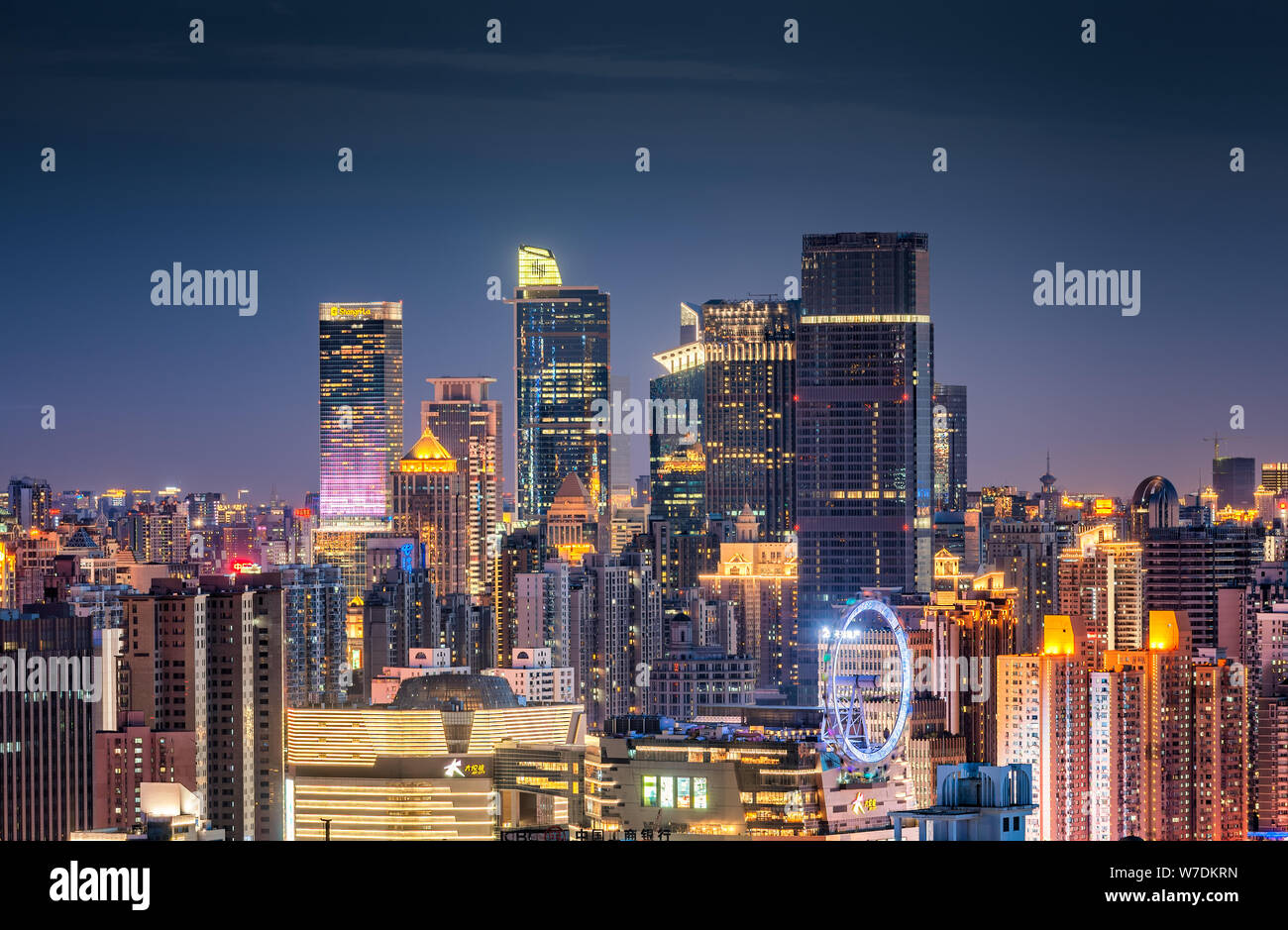 Night view of the Yu Garden or Yuyuan Garden with high-rise buildings ...
