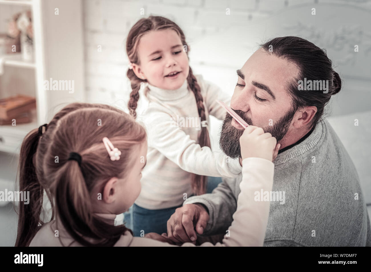 Focus on father having his beard comed by his cute children Stock Photo ...