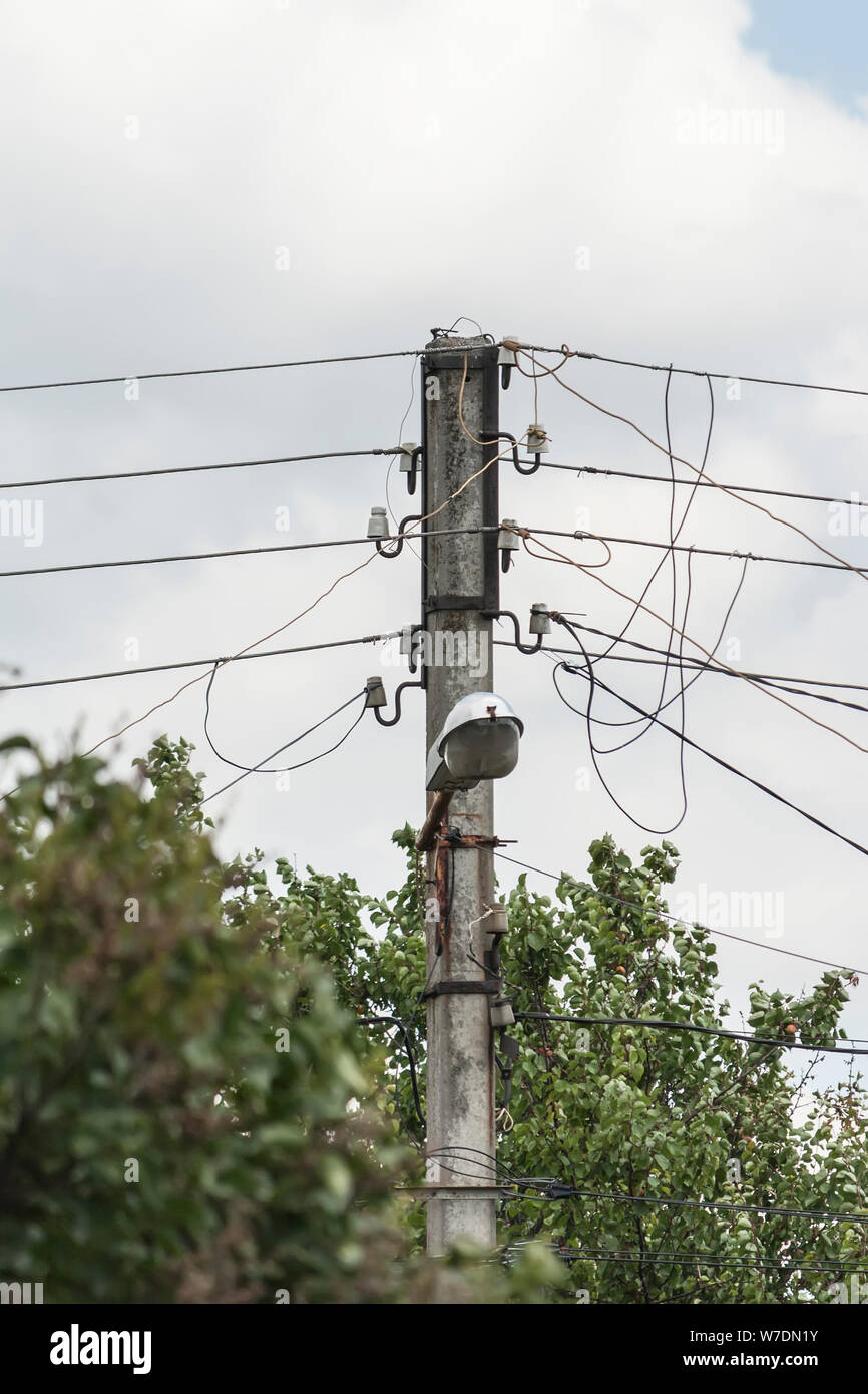 Old electric street post with lots of wires. electric wires against the ...