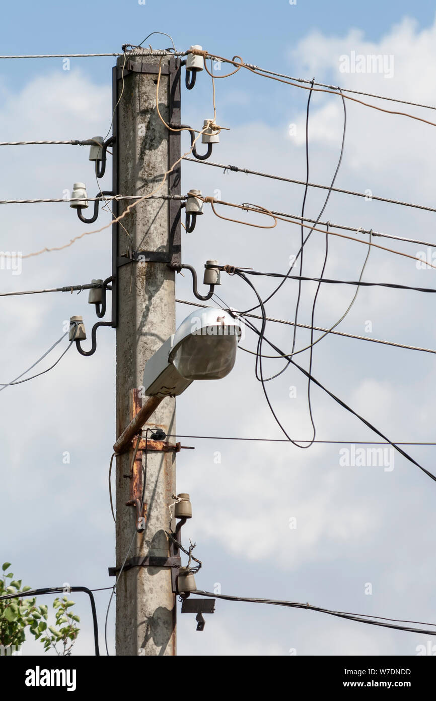 Old electric street post with lots of wires. electric wires against the ...