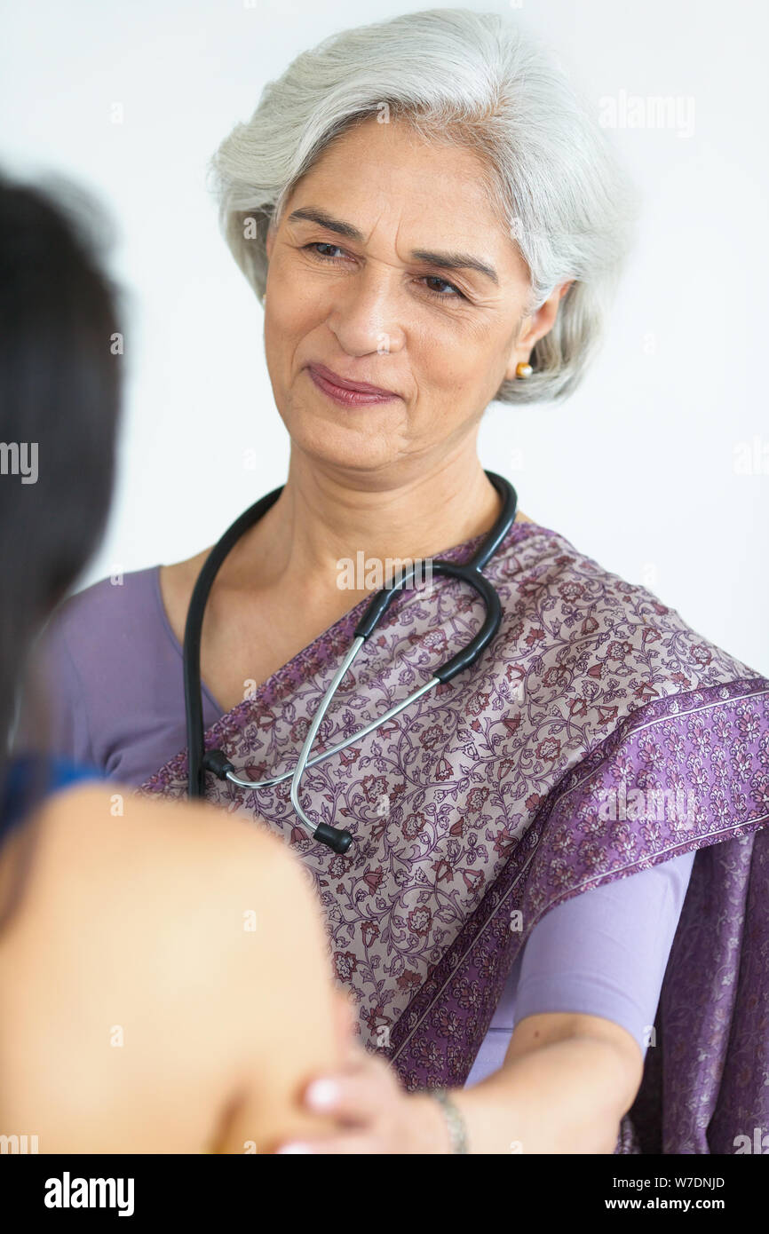 Female doctor talking with a patient Stock Photo - Alamy