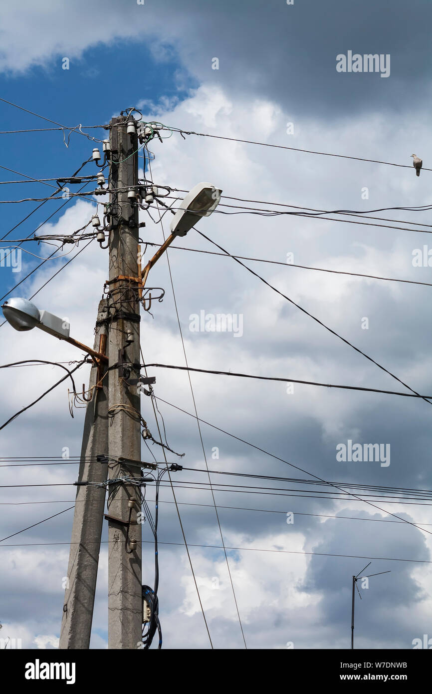 Old electric street post with lots of wires. electric wires against the ...