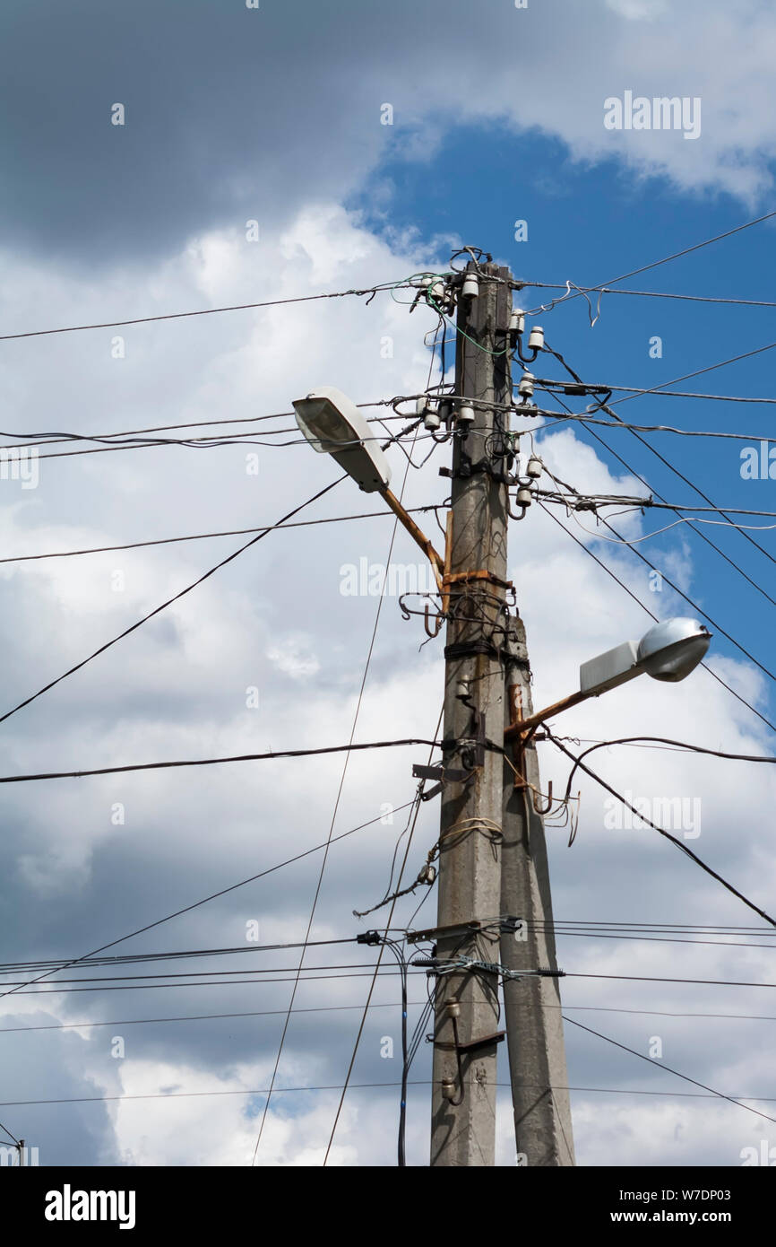 Old electric street post with lots of wires. electric wires against the ...