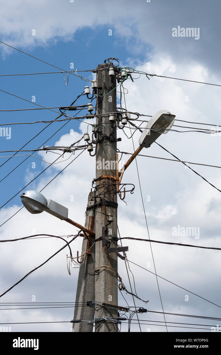 Old electric street post with lots of wires. electric wires against the ...