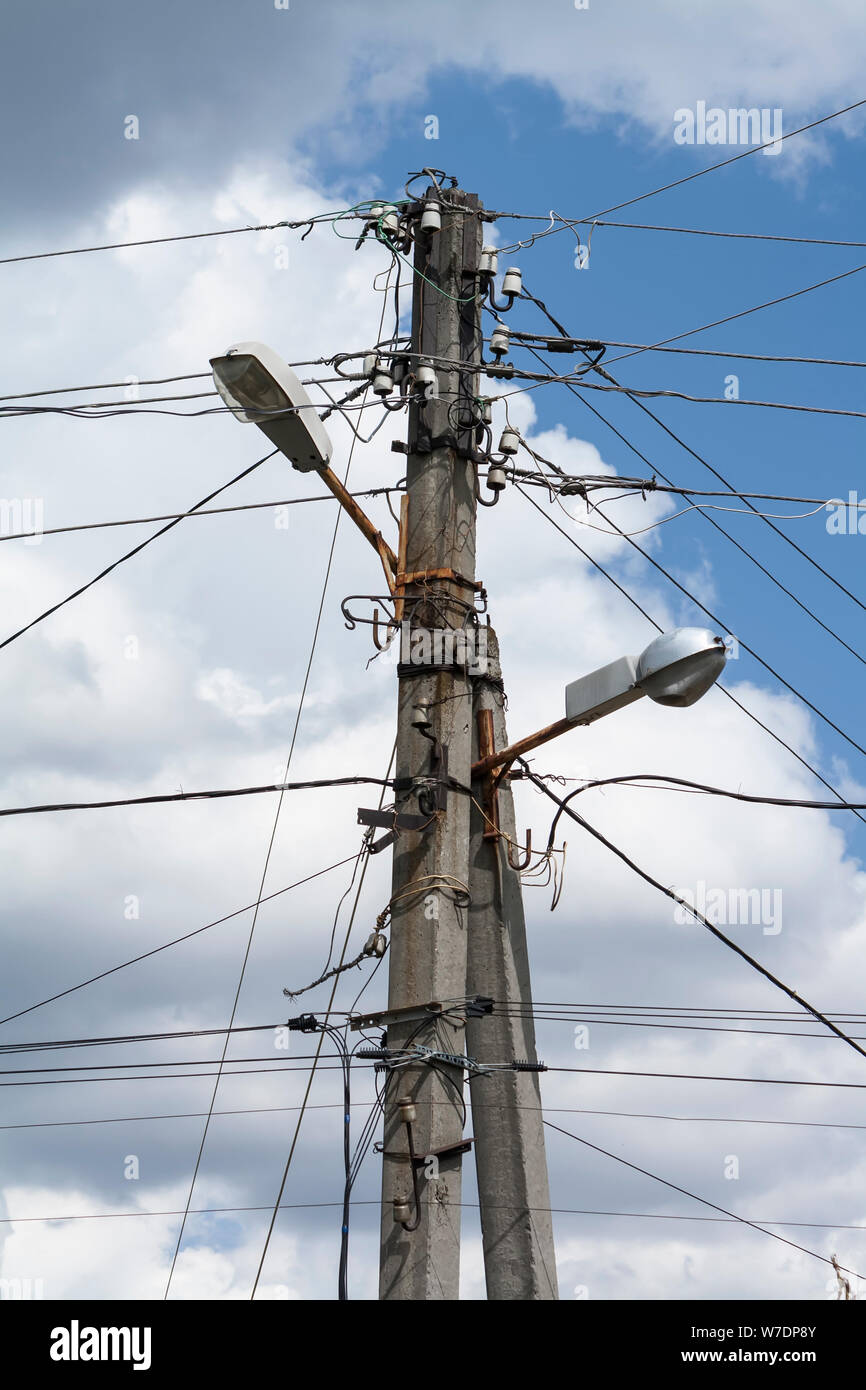 Old electric street post with lots of wires. electric wires against the ...