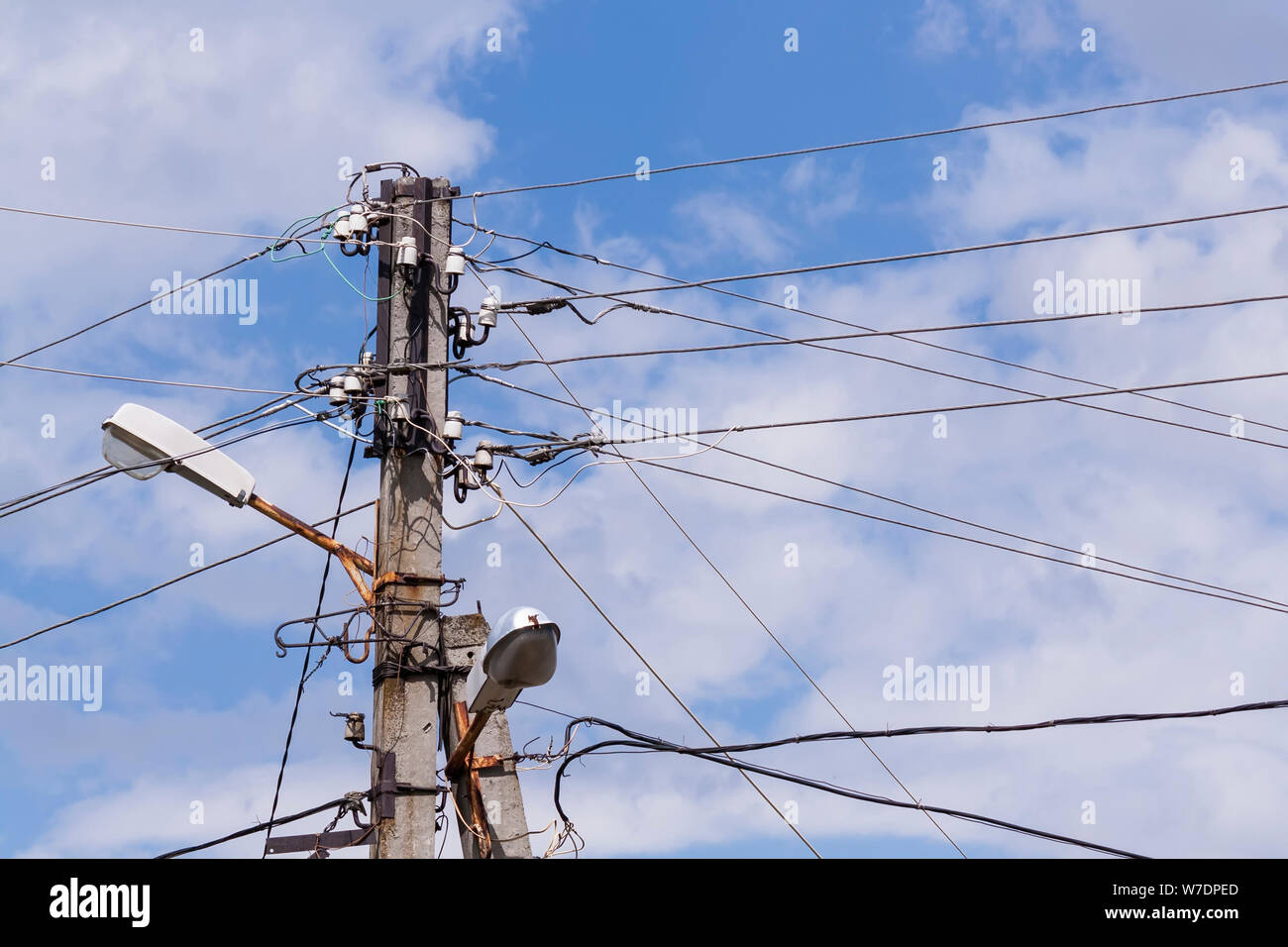 Old electric street post with lots of wires. electric wires against the ...