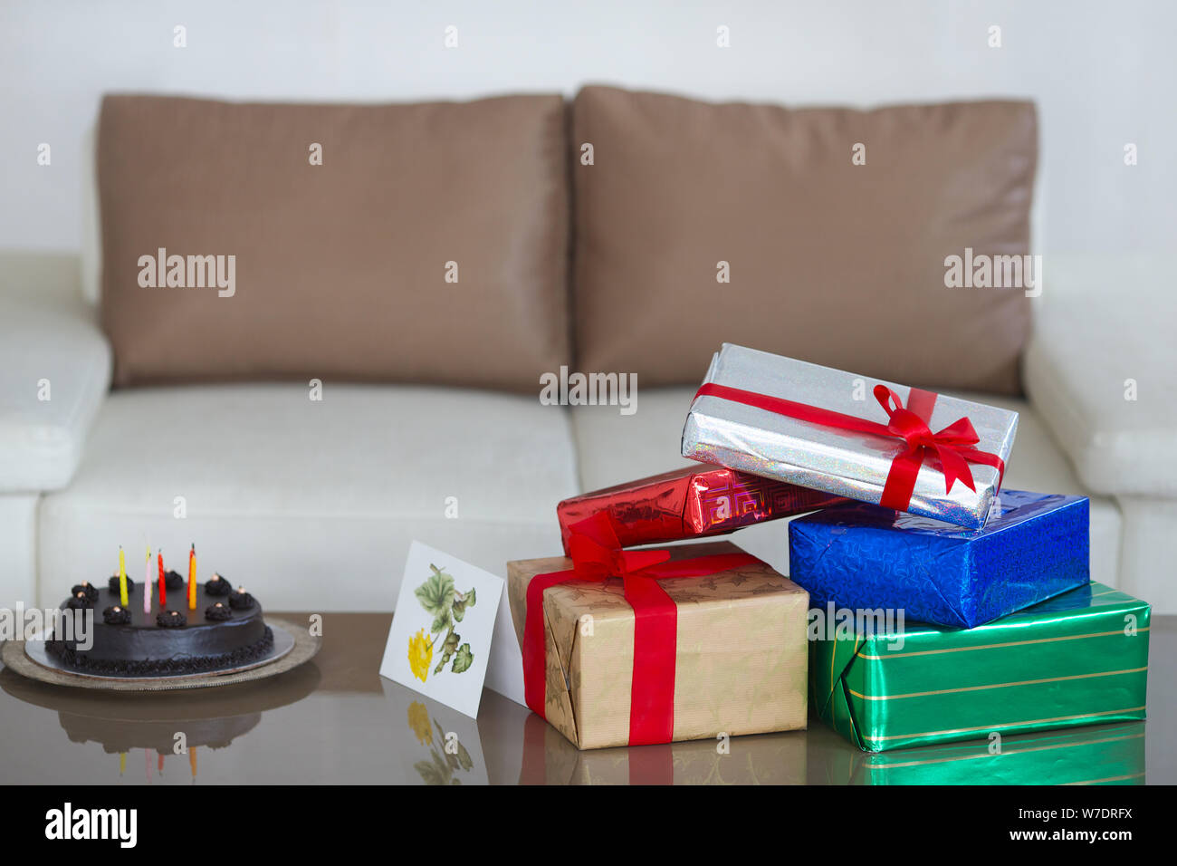 Birthday cake with gifts on the table Stock Photo - Alamy