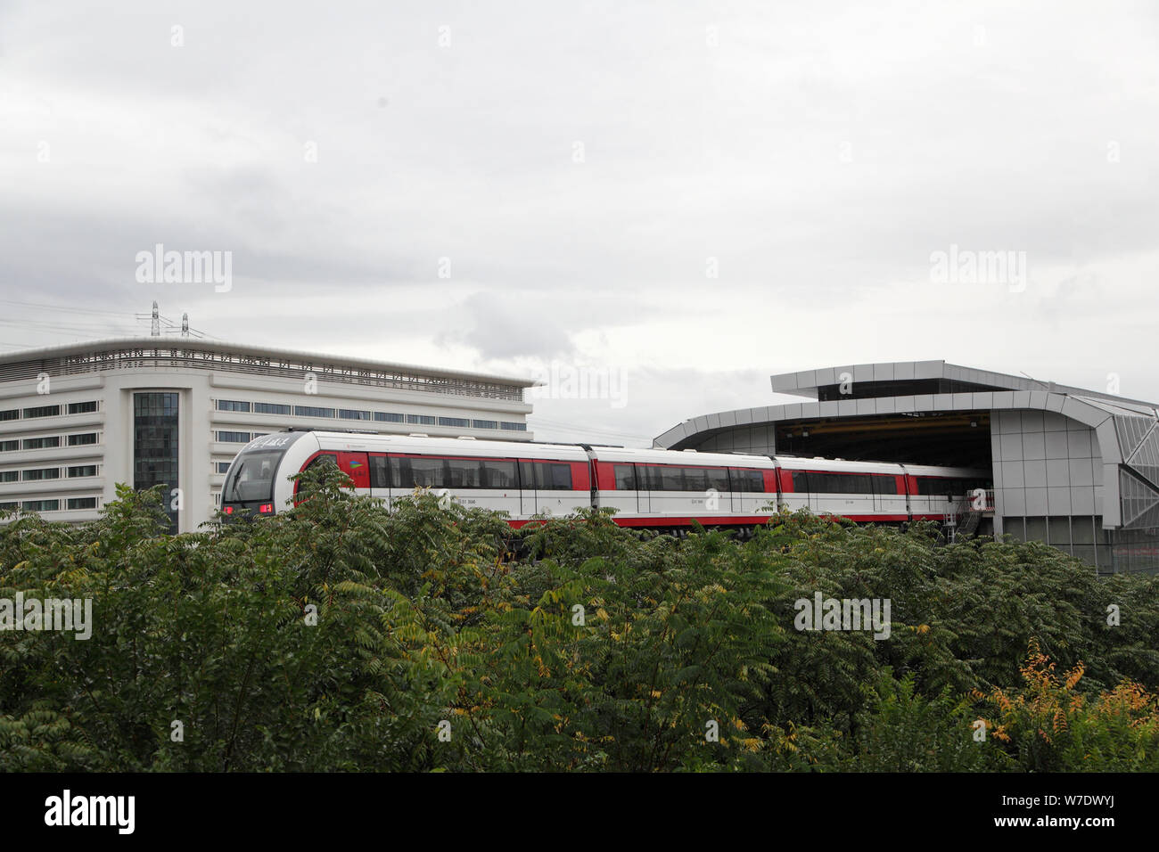 A maglev train runs in heavy rain during a trial operation in Beijing ...