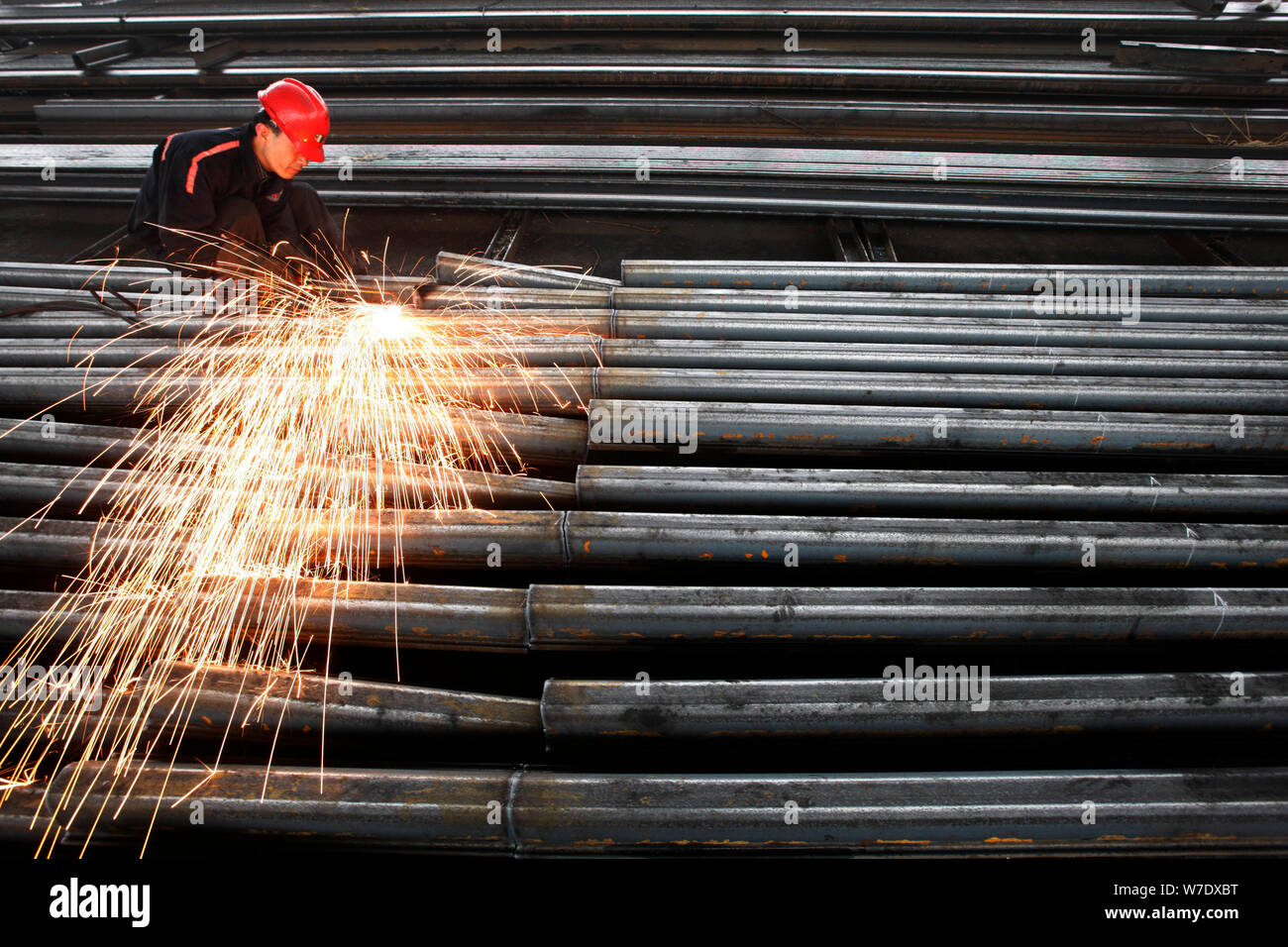 --FILE--A Chinese worker processes steel products at a factory in ...