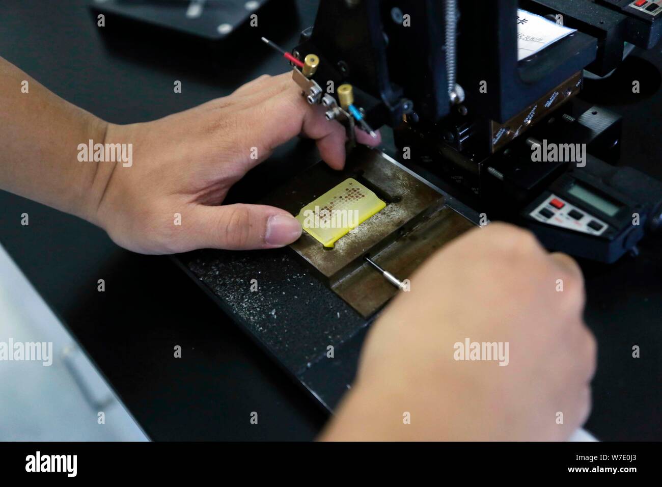 A Chinese researcher does experiments in a lab at the China's largest ...