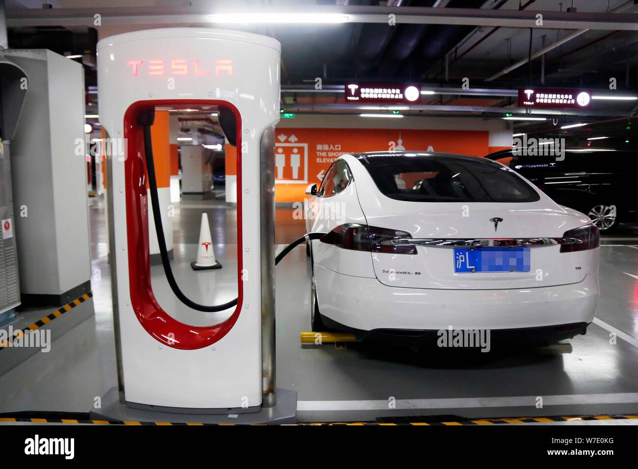 A Tesla electric car is being charged at the world's largest ...