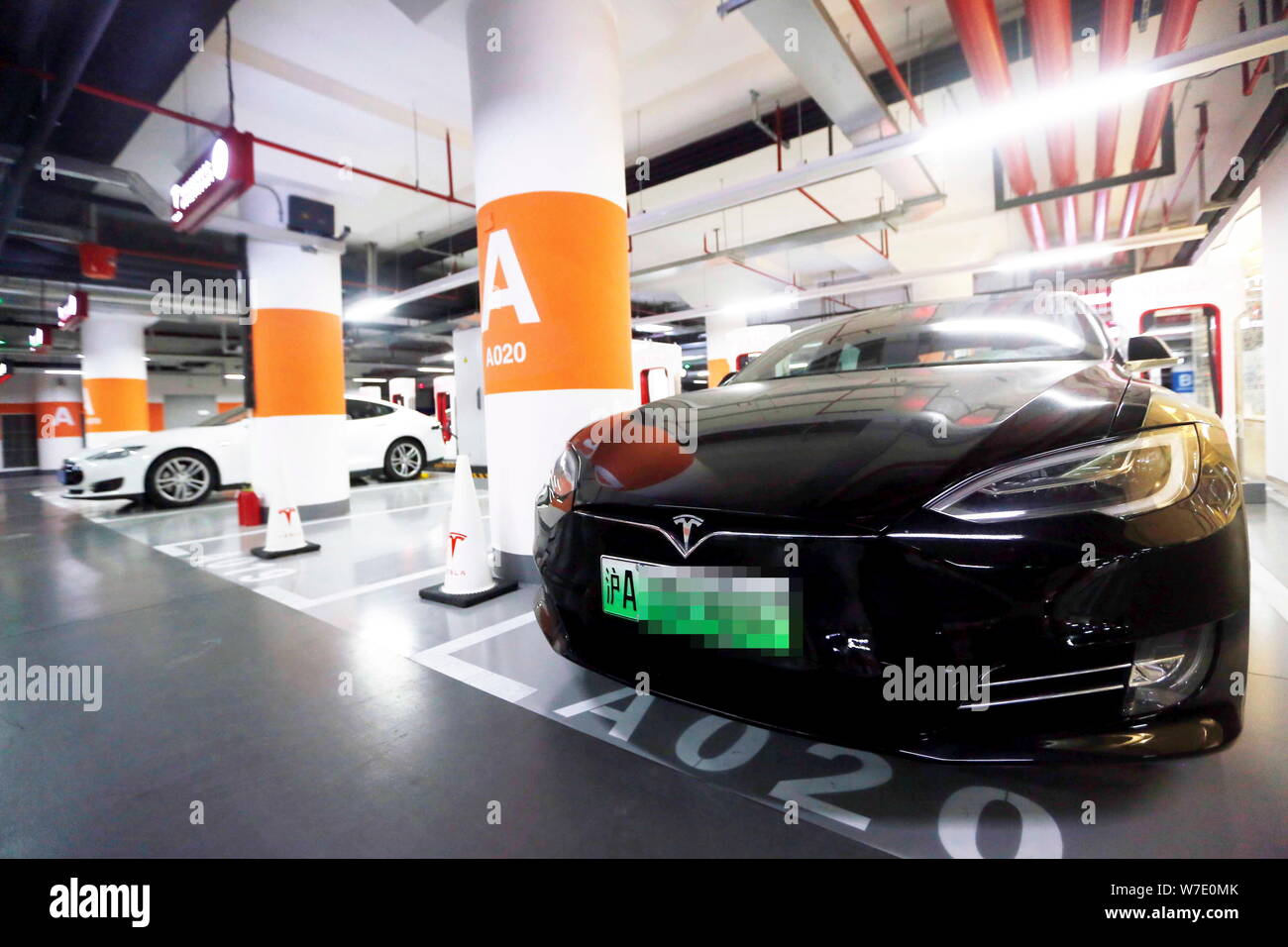 A Tesla electric car is being charged at the world's largest ...