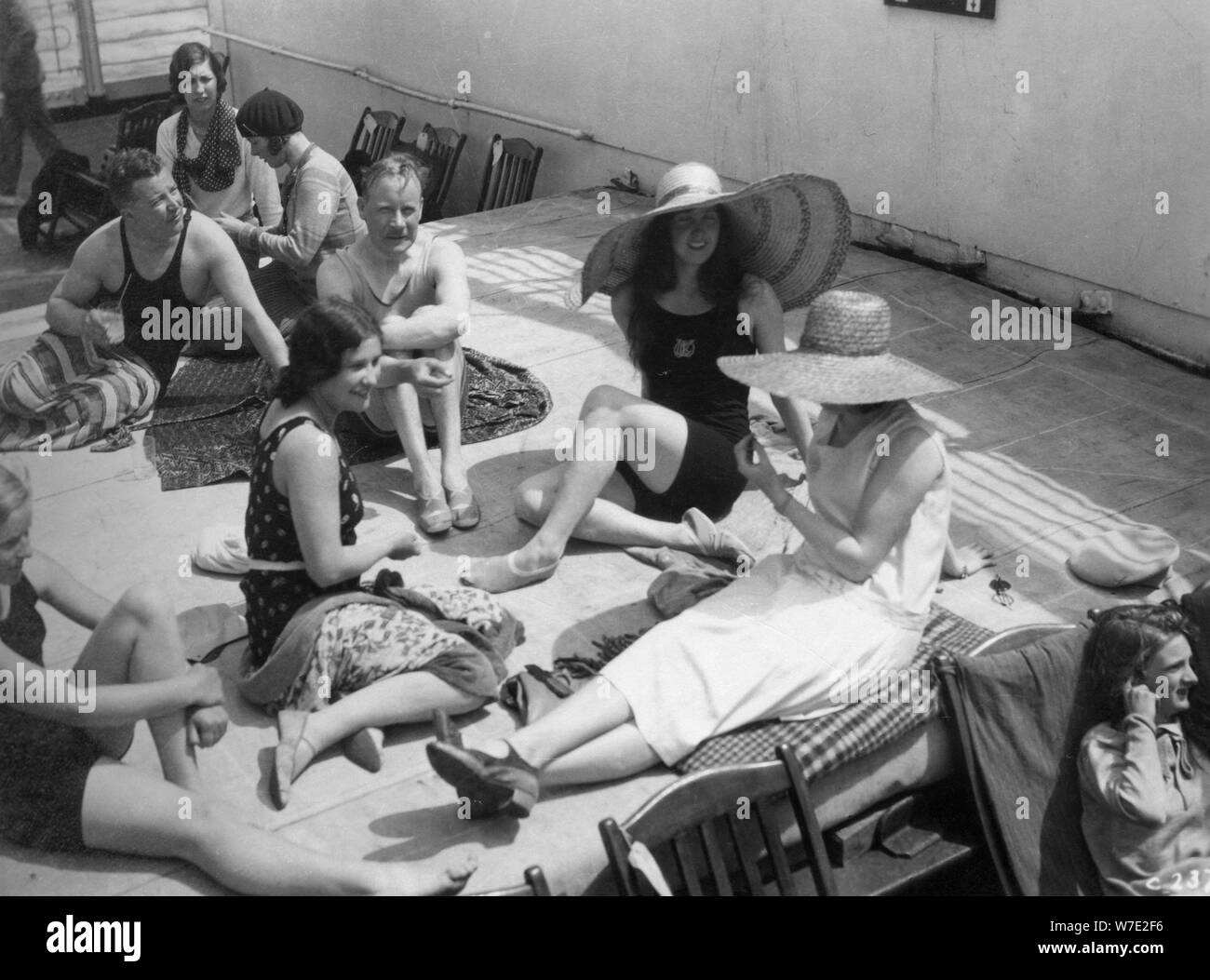 Passengers sunbathing on board a cruise ship, c1920s-c1930s(?). Artist ...