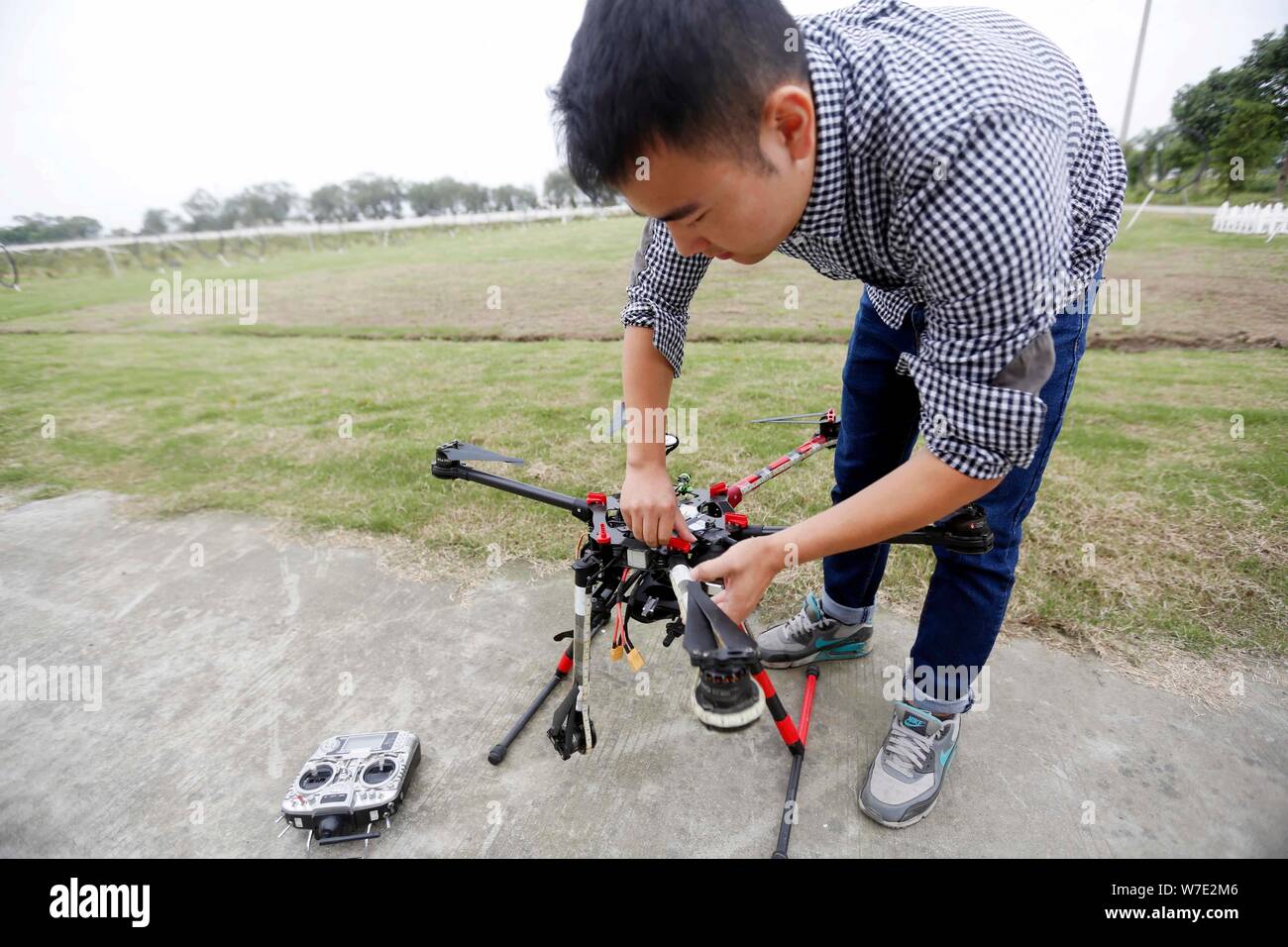 A Chinese enthusiast checks a drone, or UAV (unmanned aerial vehicle ...