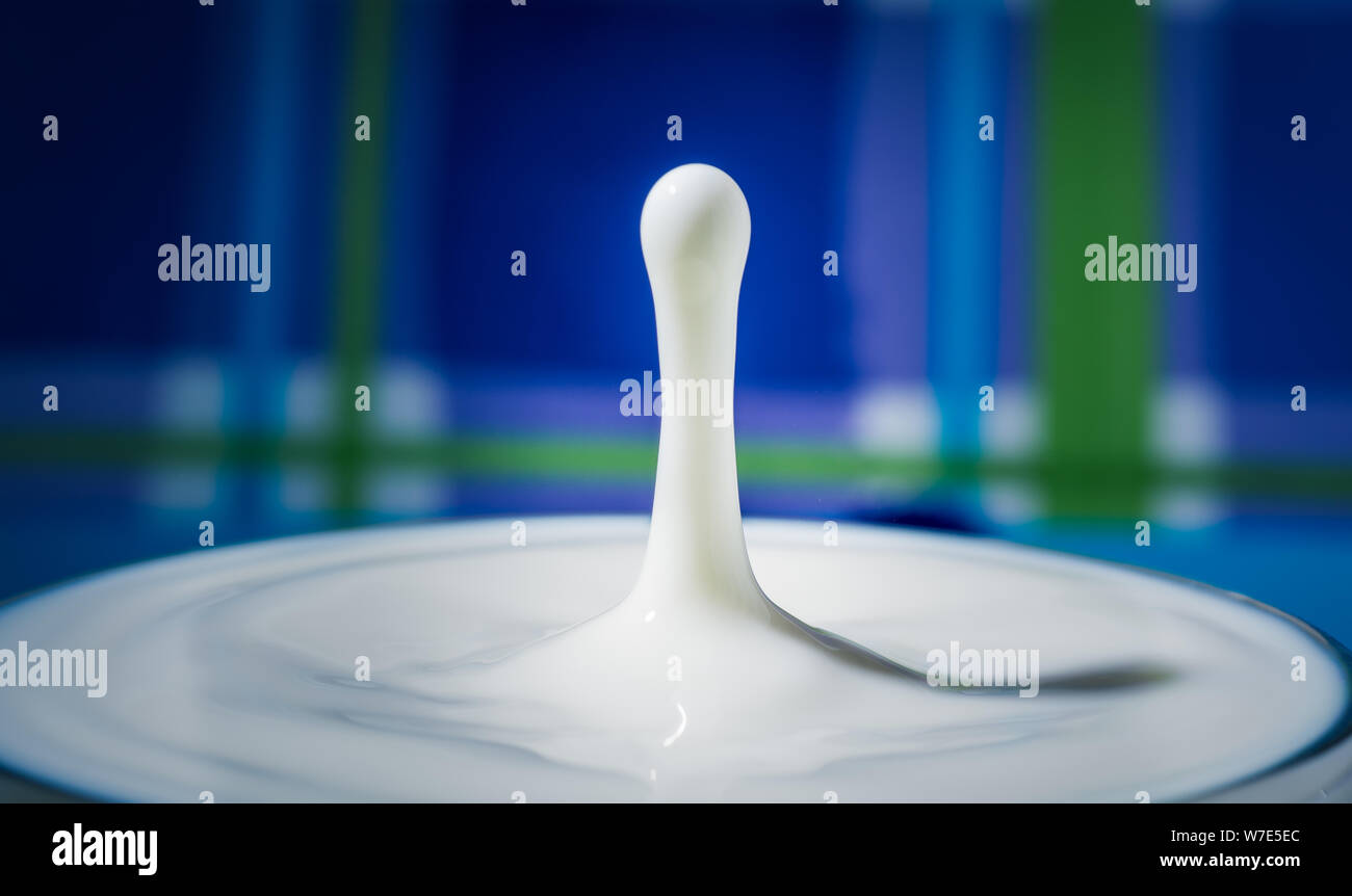 Fresh milk droplet isolated on interesting colourful background - dairy ...