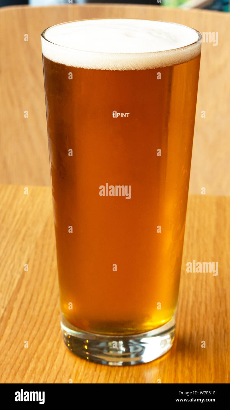 A cool pint of larger in a thin glass Stock Photo - Alamy