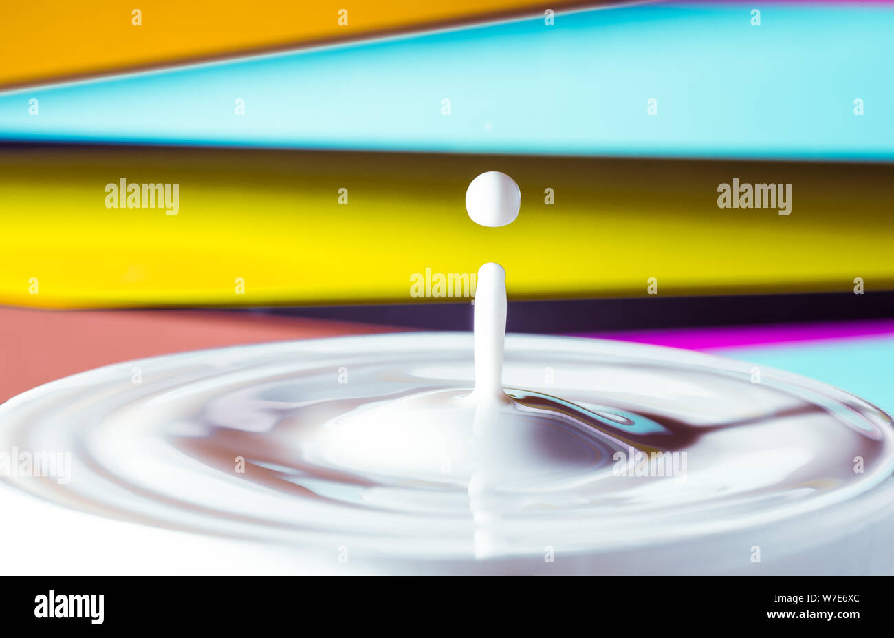 Fresh milk droplet isolated on interesting colourful background - dairy ...