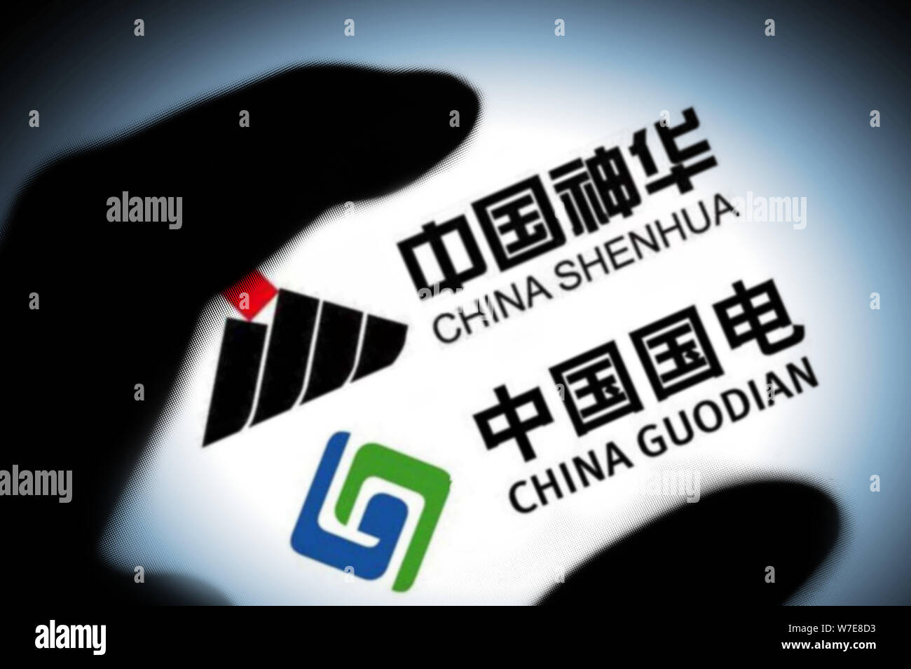 --FILE--A Chinese netizen looks at logos of China Shenhua and China ...