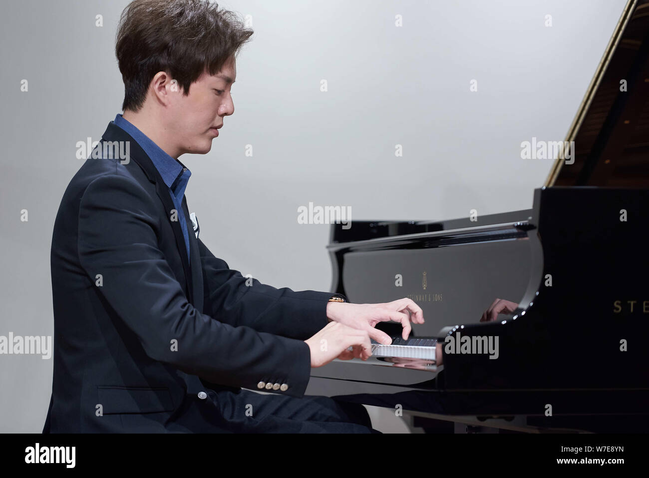 Chinese pianist Li Yundi shows his piano skills during his master class ...