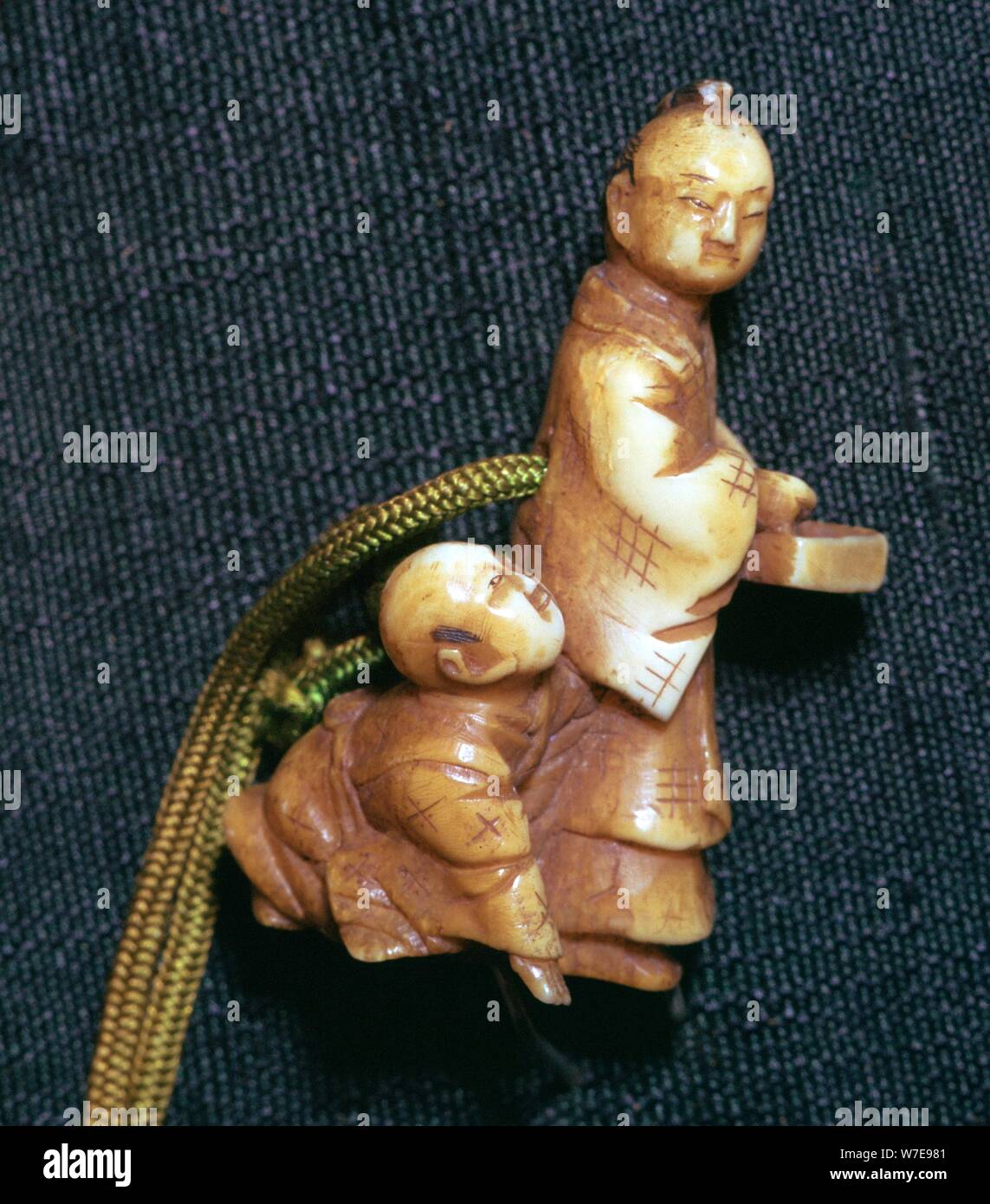Japanese Netsuke of a man and boy at new year, 19th century. Artist ...
