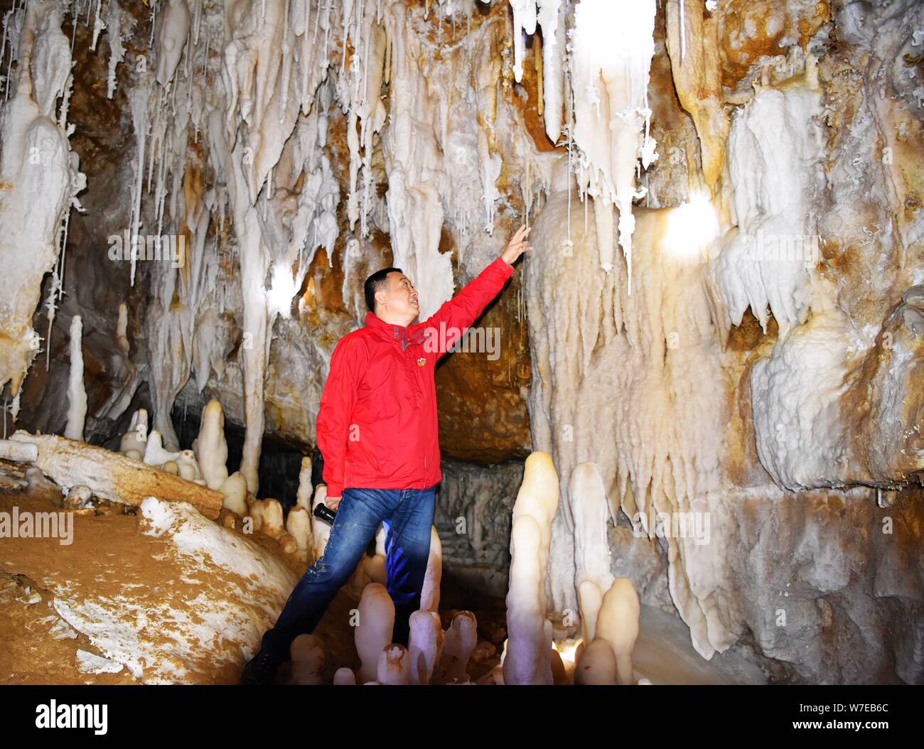 A visitor views the snow-white stalactites and stalagmites in the Snow ...