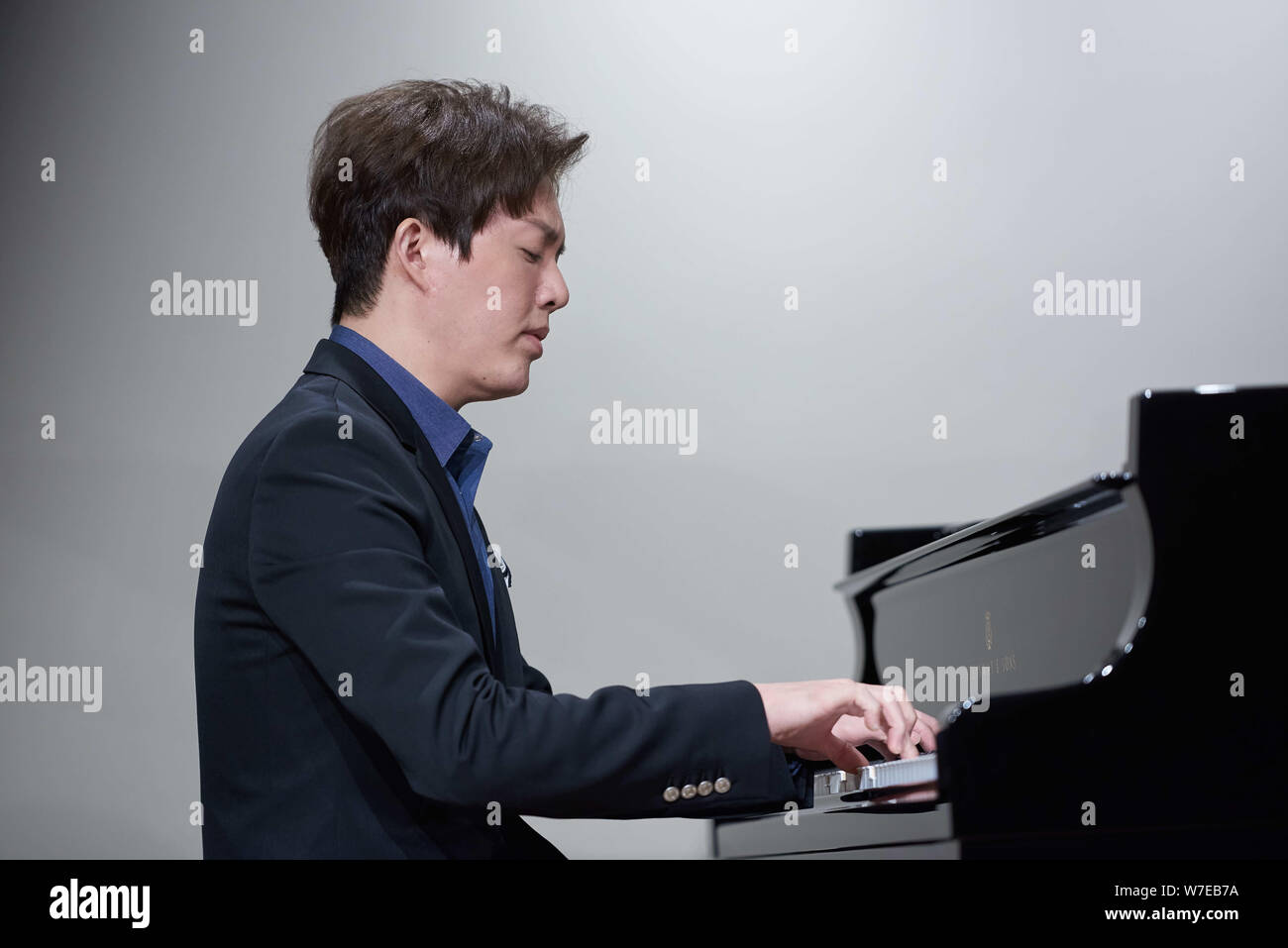 Chinese pianist Li Yundi shows his piano skills during his master class ...