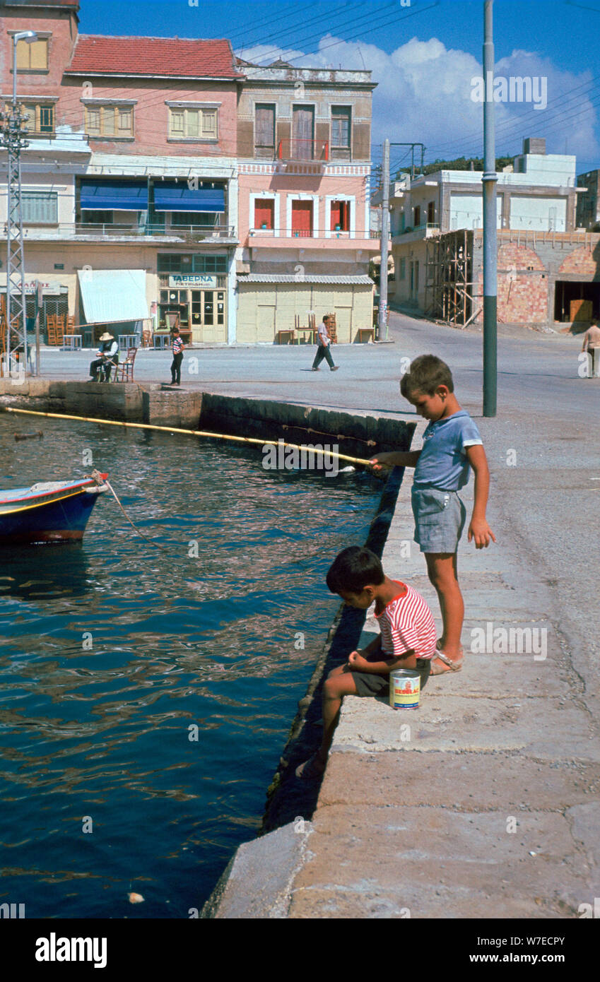 Children fishing in the harbour of Khania. Artist: Unknown Stock Photo ...