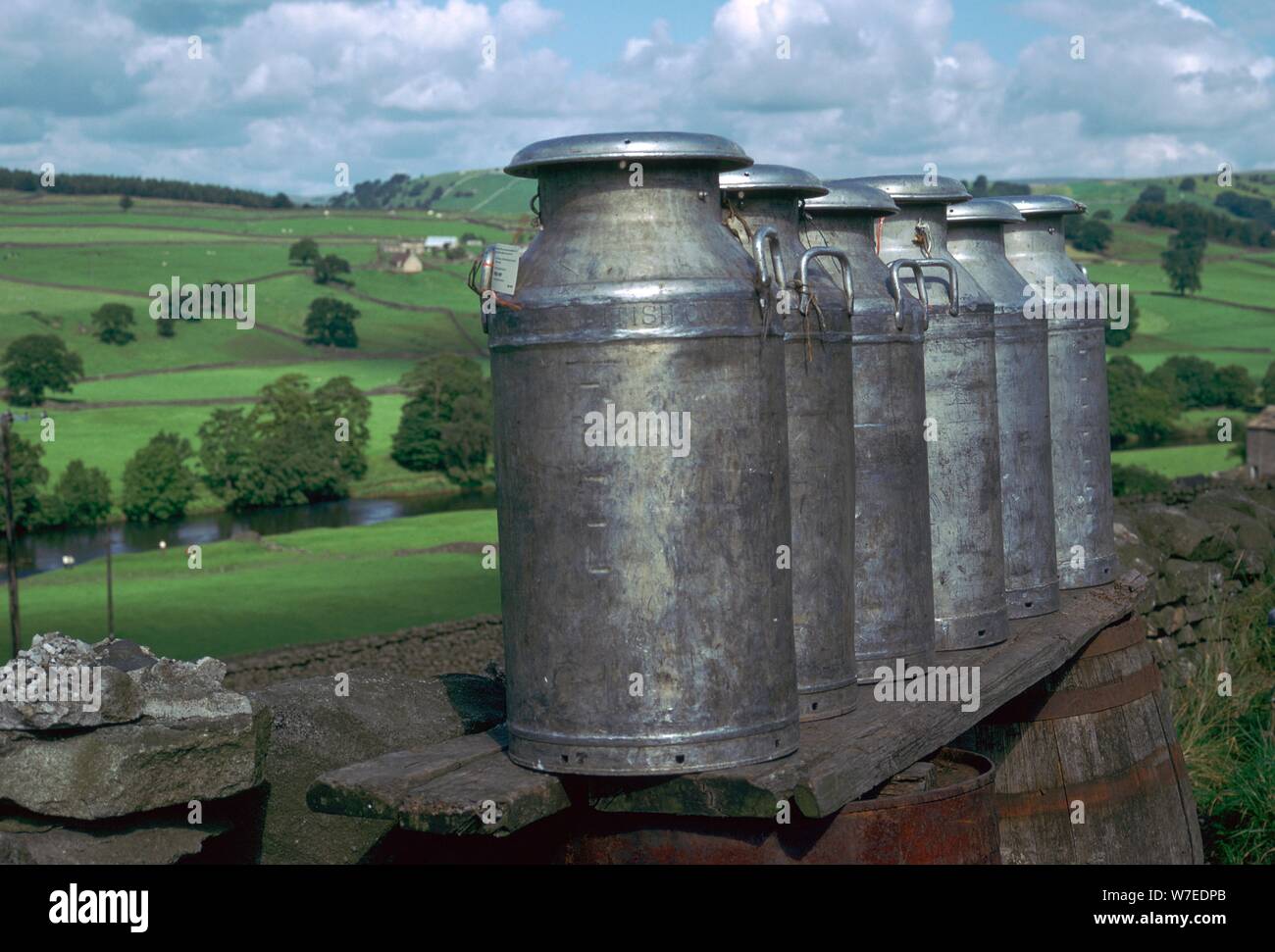 Milk cans at farm gateway Stock Photo - Alamy