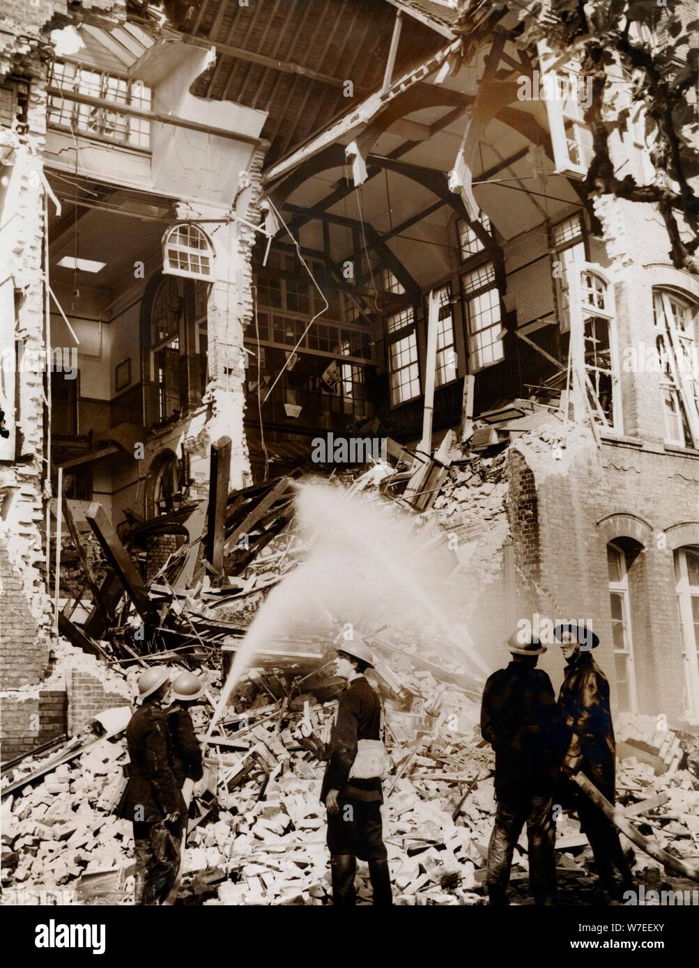 Firemen at work on a children's school, East London, the Blitz, World ...