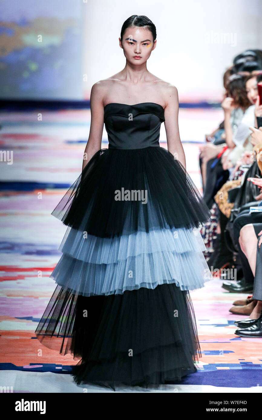 Chinese model He Cong displays a new creation at the fashion show of ...