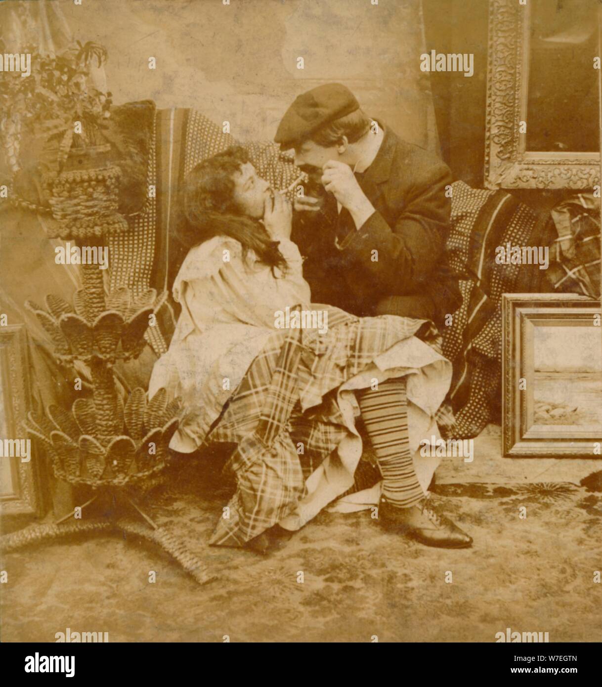 Couple lighting a cigarette from each other, 1900. Artist: Unknown ...