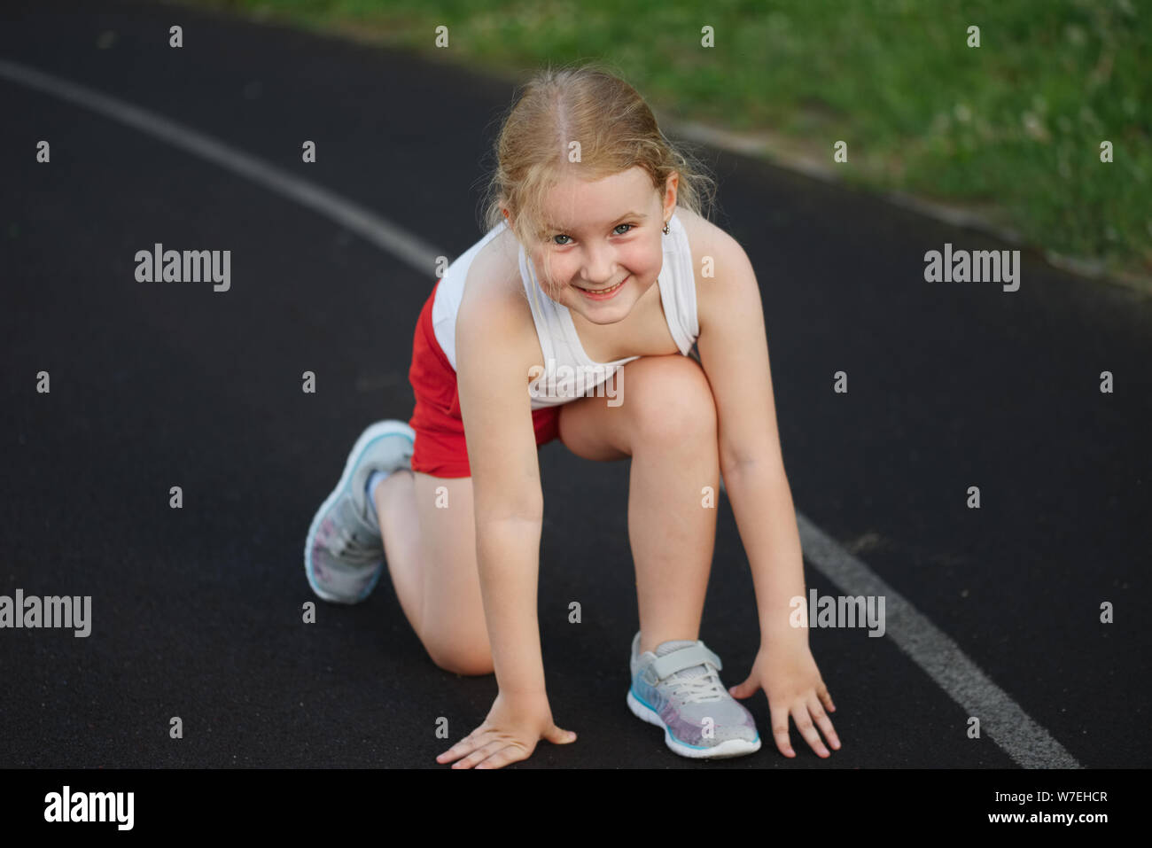 happy little girl running on the stadium Stock Photo - Alamy