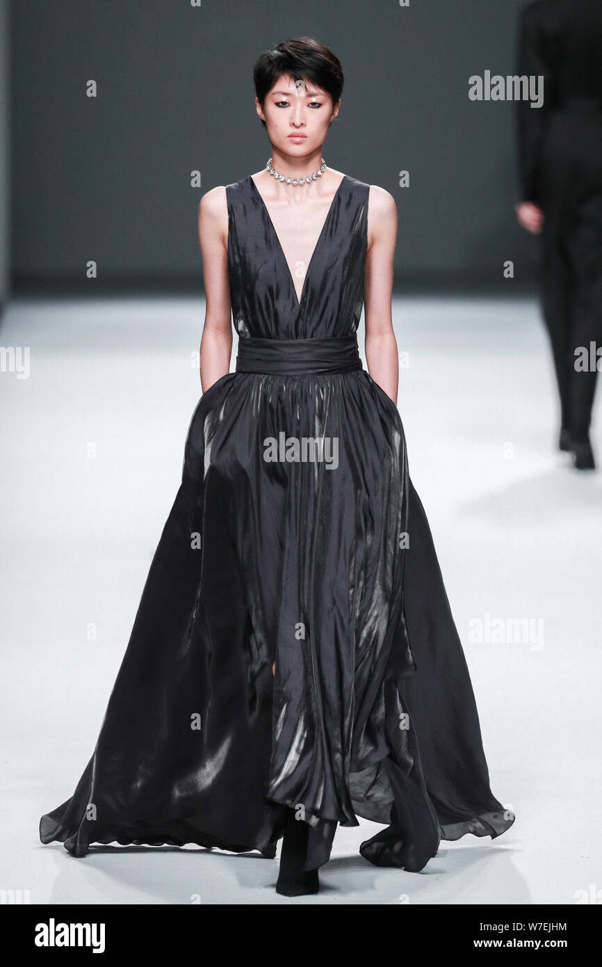 A model displays a new creation at the fashion show of Anirac during the Shanghai Fashion Week ...