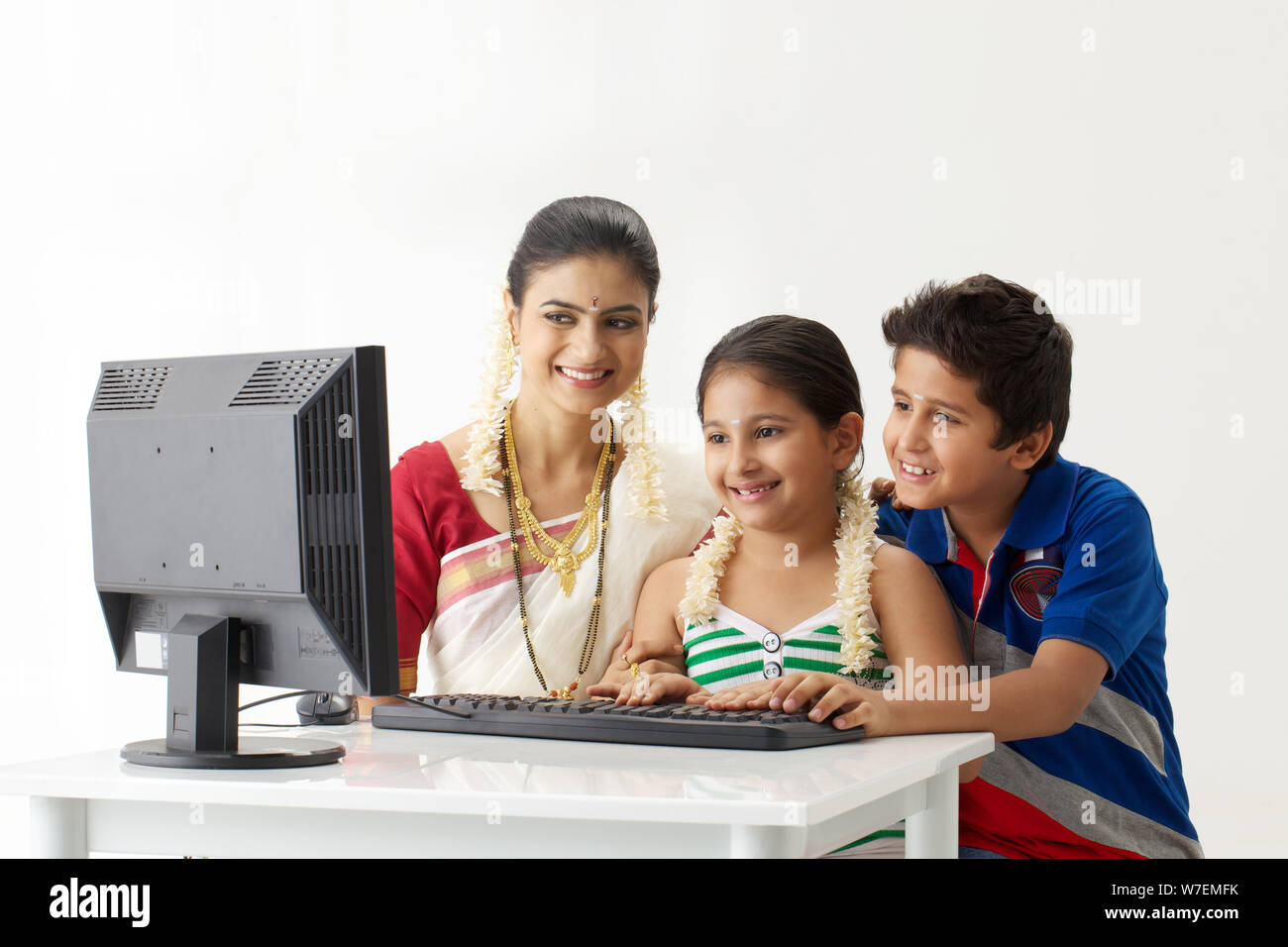 Woman with her children using a desktop pc Stock Photo - Alamy