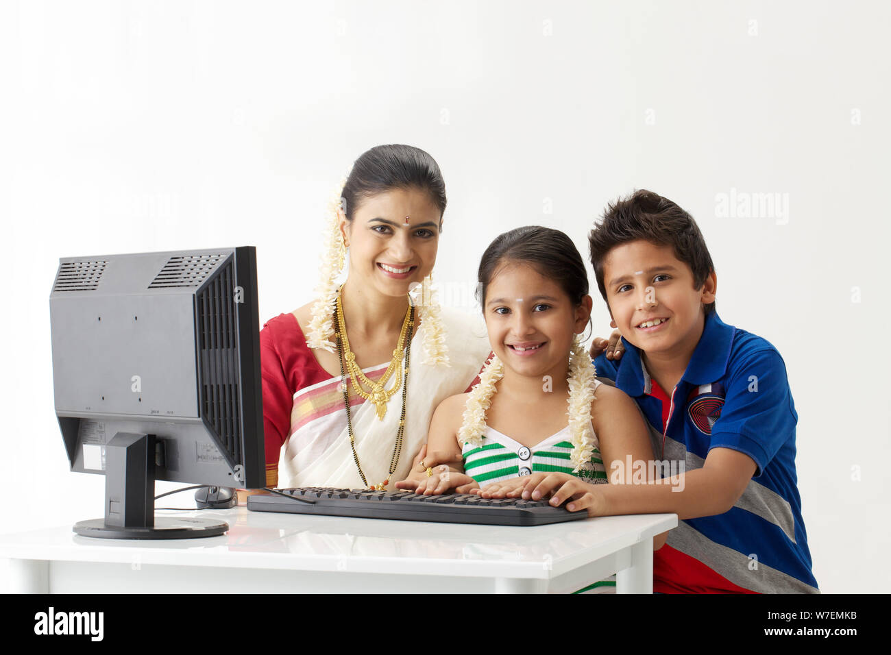 Woman with her children using a desktop pc Stock Photo - Alamy