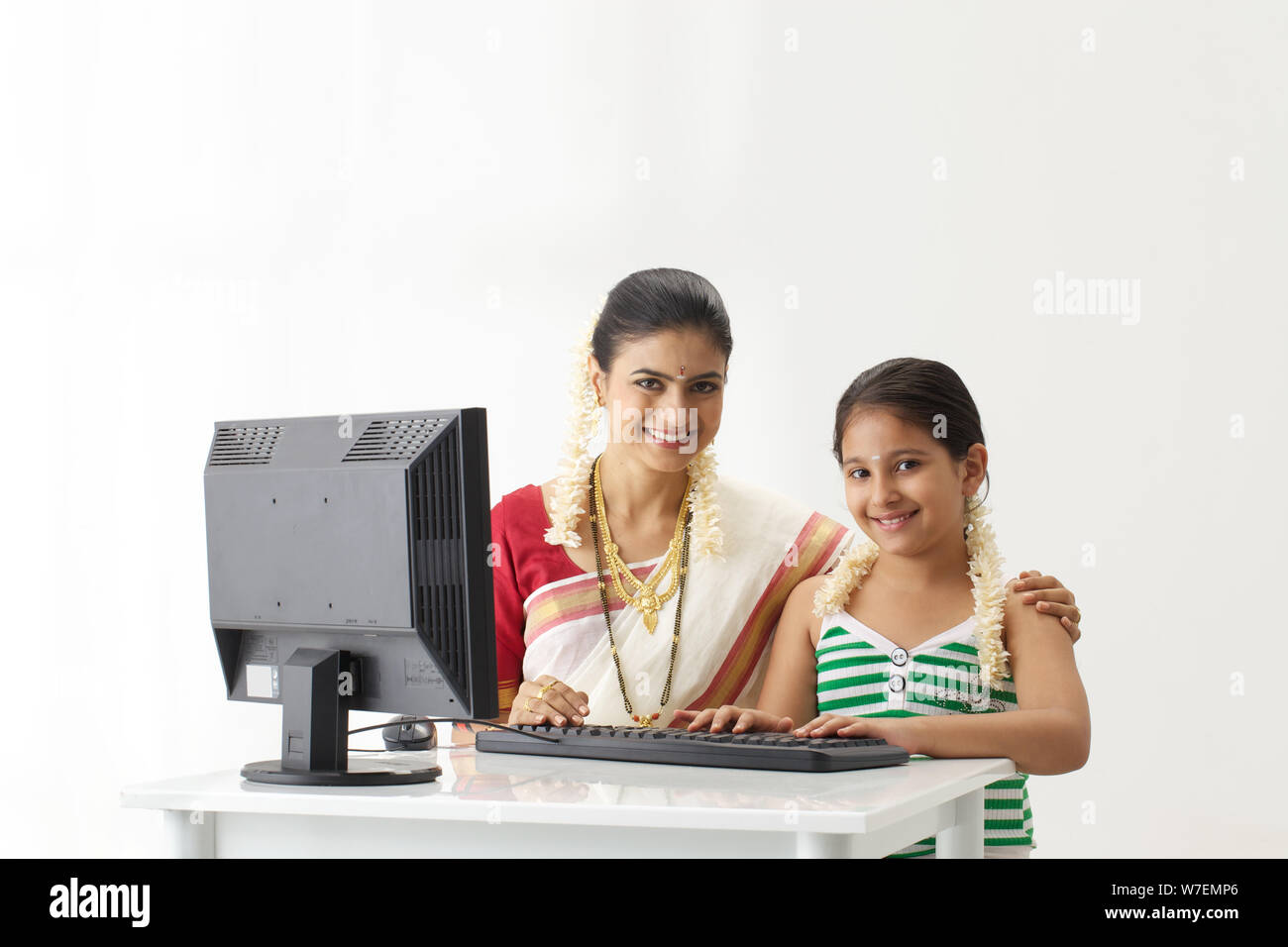 Woman with her daughter using a desktop pc Stock Photo - Alamy