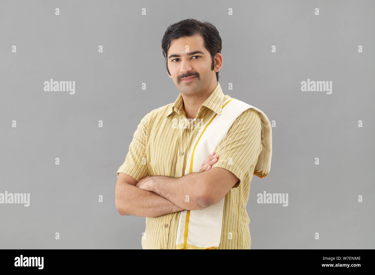 South Indian man standing with his arms crossed Stock Photo - Alamy