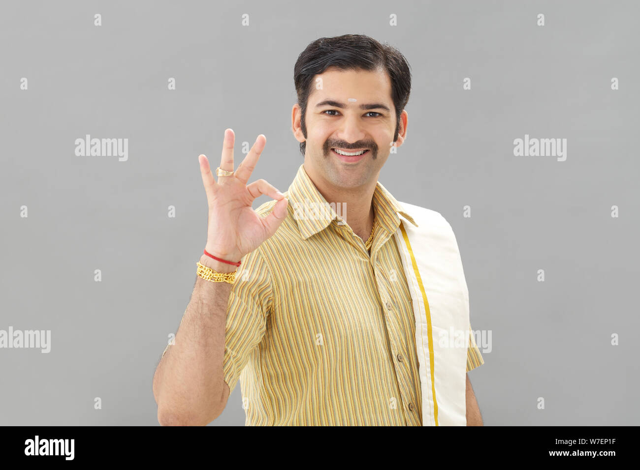South Indian man showing ok sign Stock Photo - Alamy