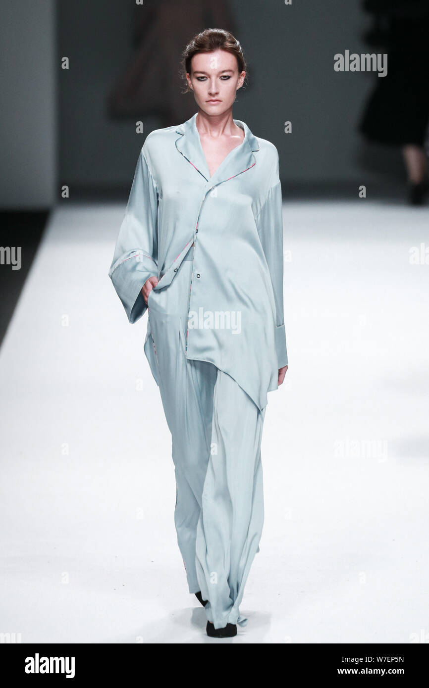 A model displays a new creation at the fashion show of Anirac during the Shanghai Fashion Week ...