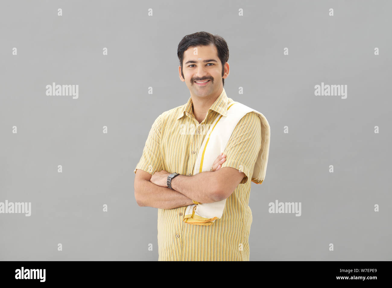 South Indian man standing with his arms crossed Stock Photo - Alamy