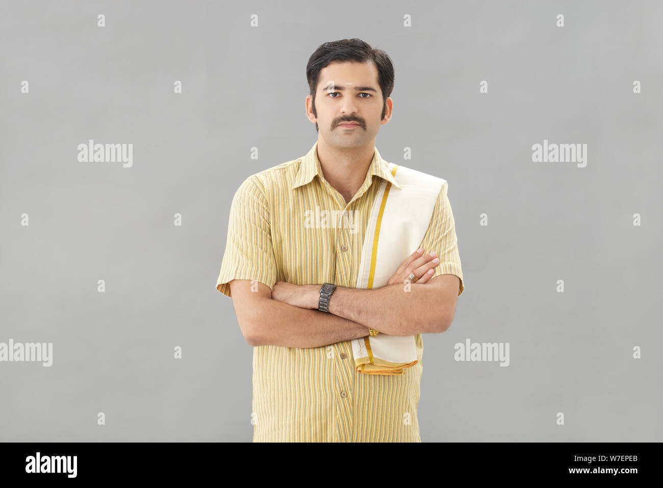 South Indian man standing with his arms crossed Stock Photo - Alamy