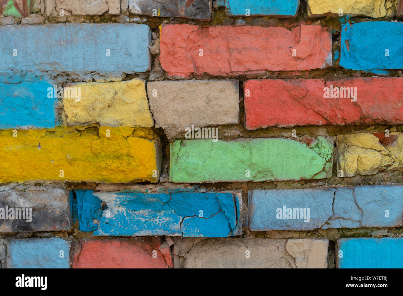 Rainbow colourful brick wall background. Rough texture. Abstract ...