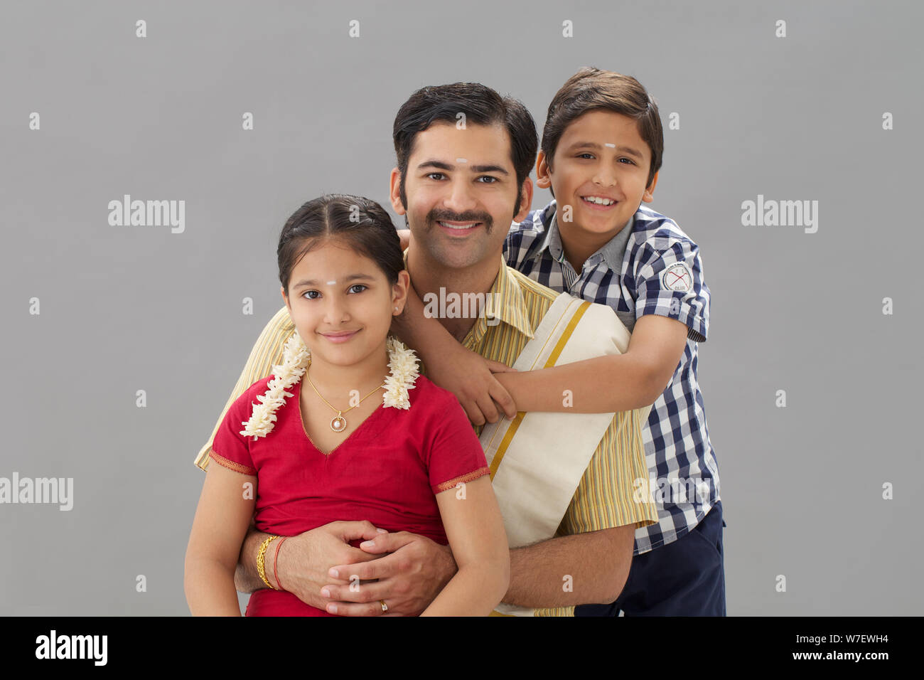 Portrait of a South Indian man smiling with his children Stock Photo ...