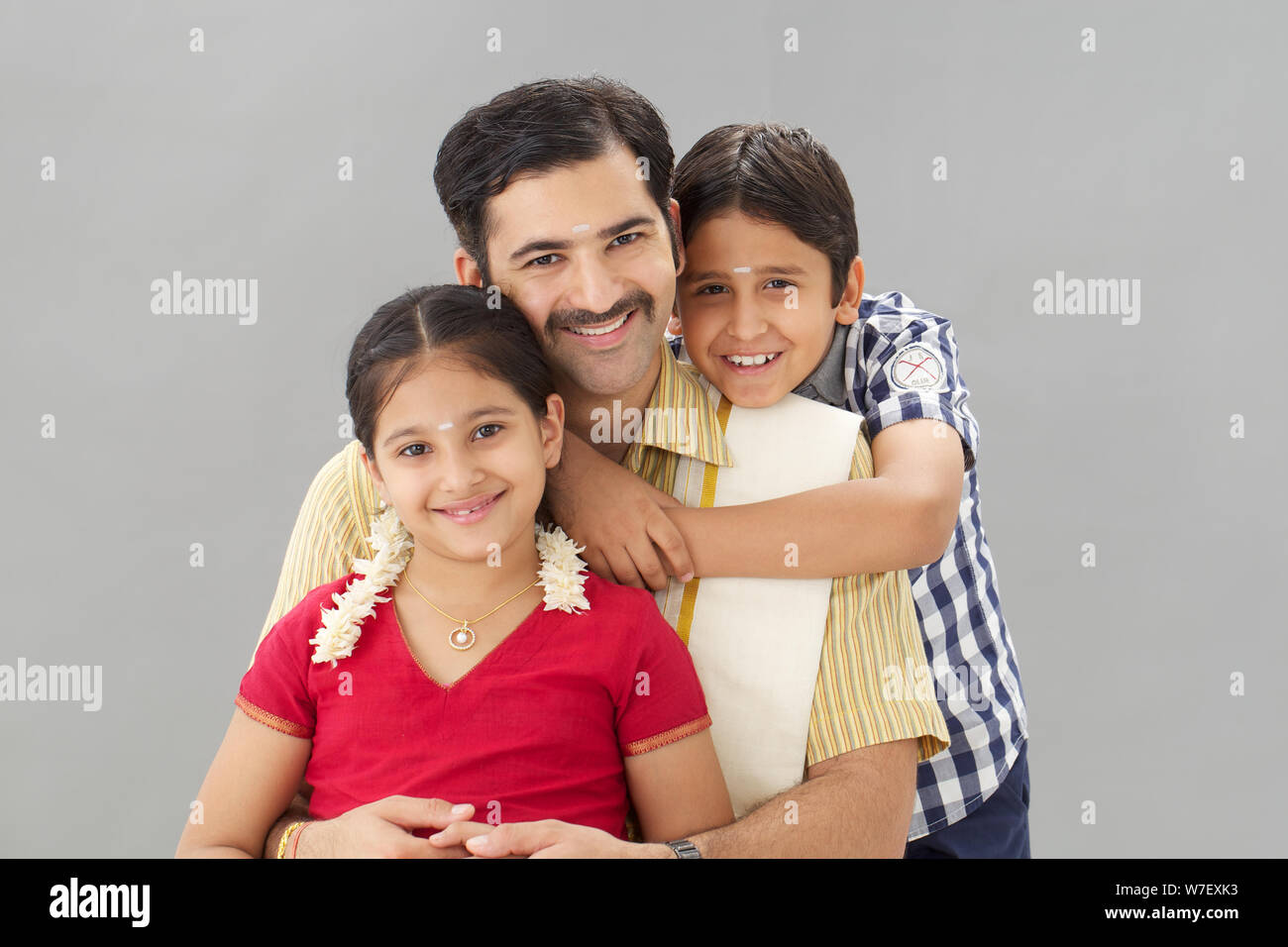 Portrait of a South Indian man smiling with his children Stock Photo ...