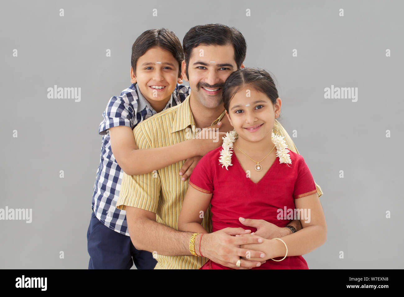 Portrait of a South Indian man smiling with his children Stock Photo ...