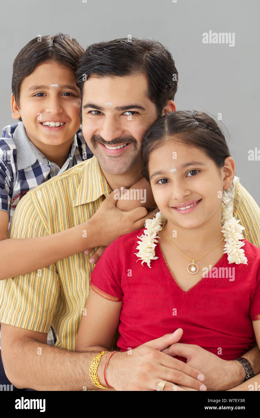 Portrait of a South Indian man smiling with his children Stock Photo ...