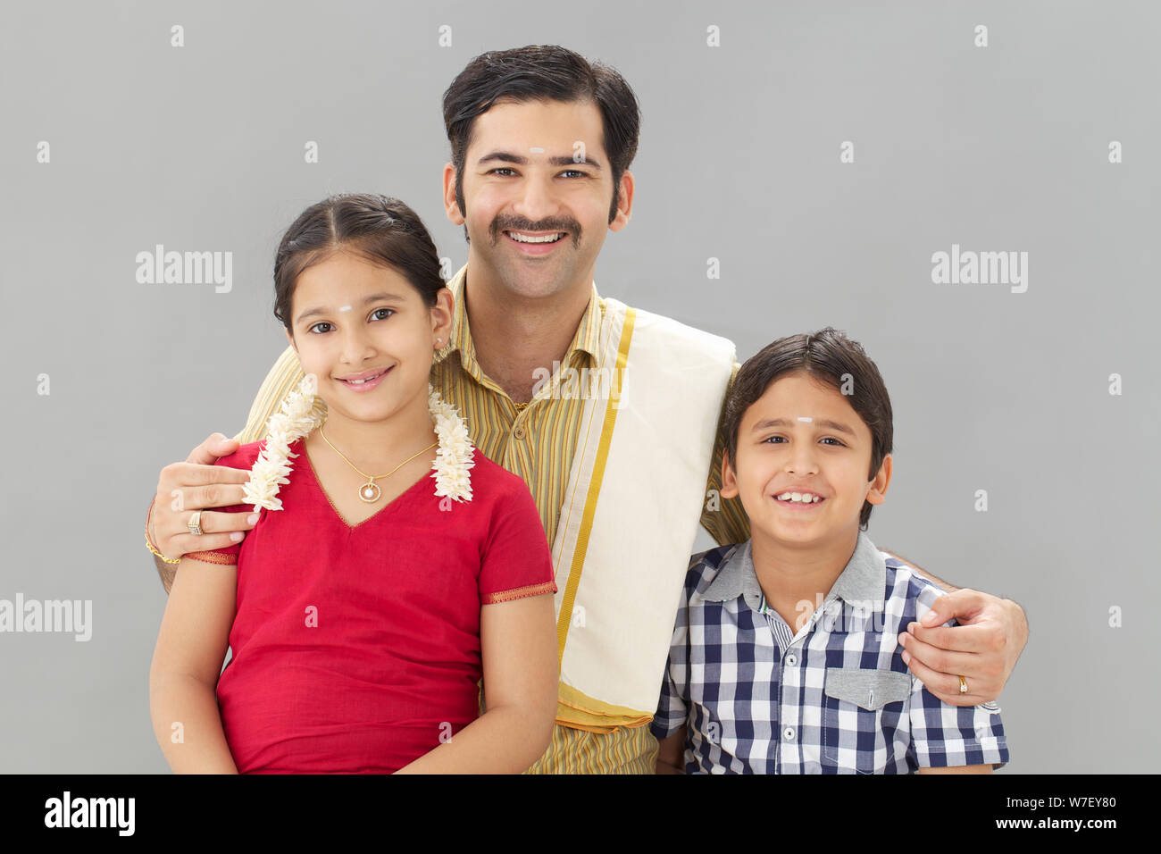 Portrait of a South Indian man smiling with his children Stock Photo ...